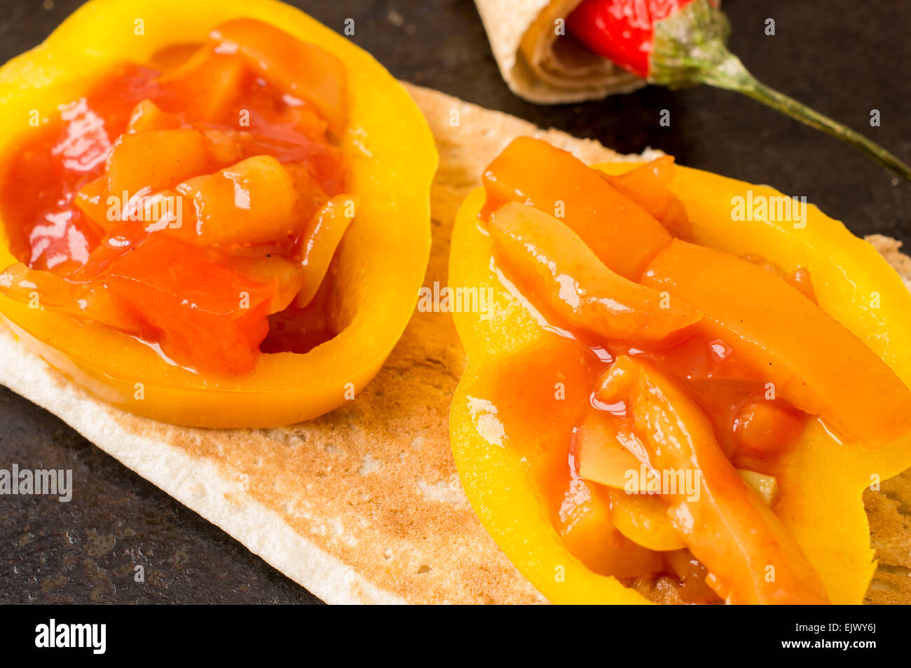 Tapas with spicy chili peppers and yellow peppers on pita bread Stock ...