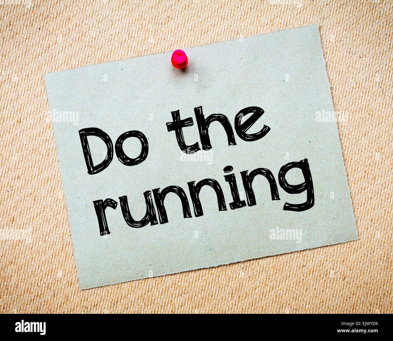 Do the running Message. Recycled paper note pinned on cork board ...