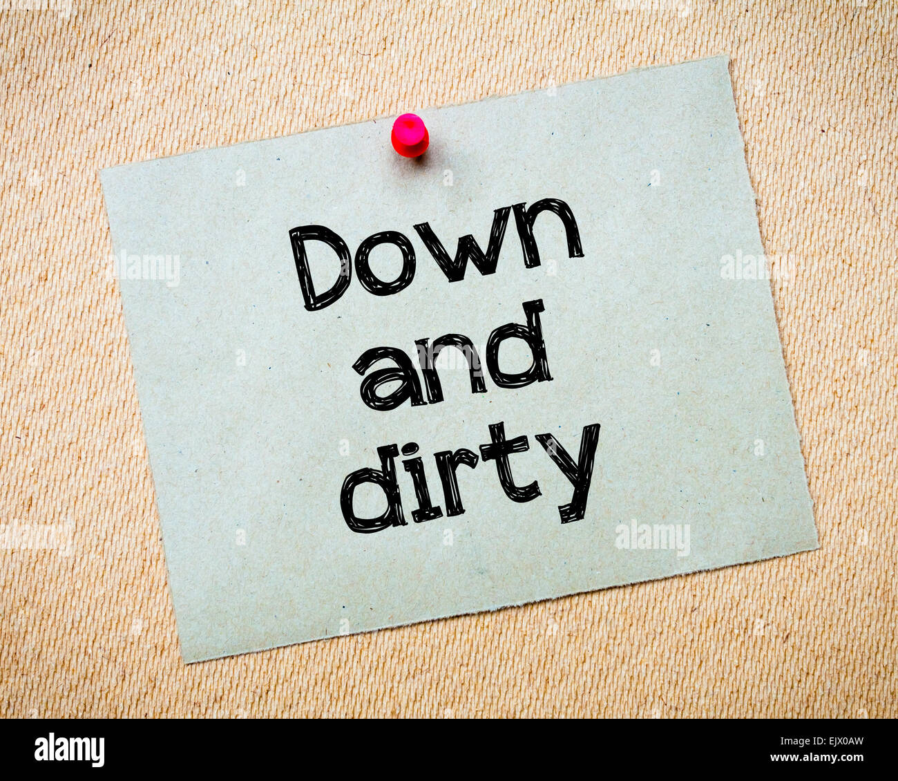 Down and dirty Message. Recycled paper note pinned on cork board ...