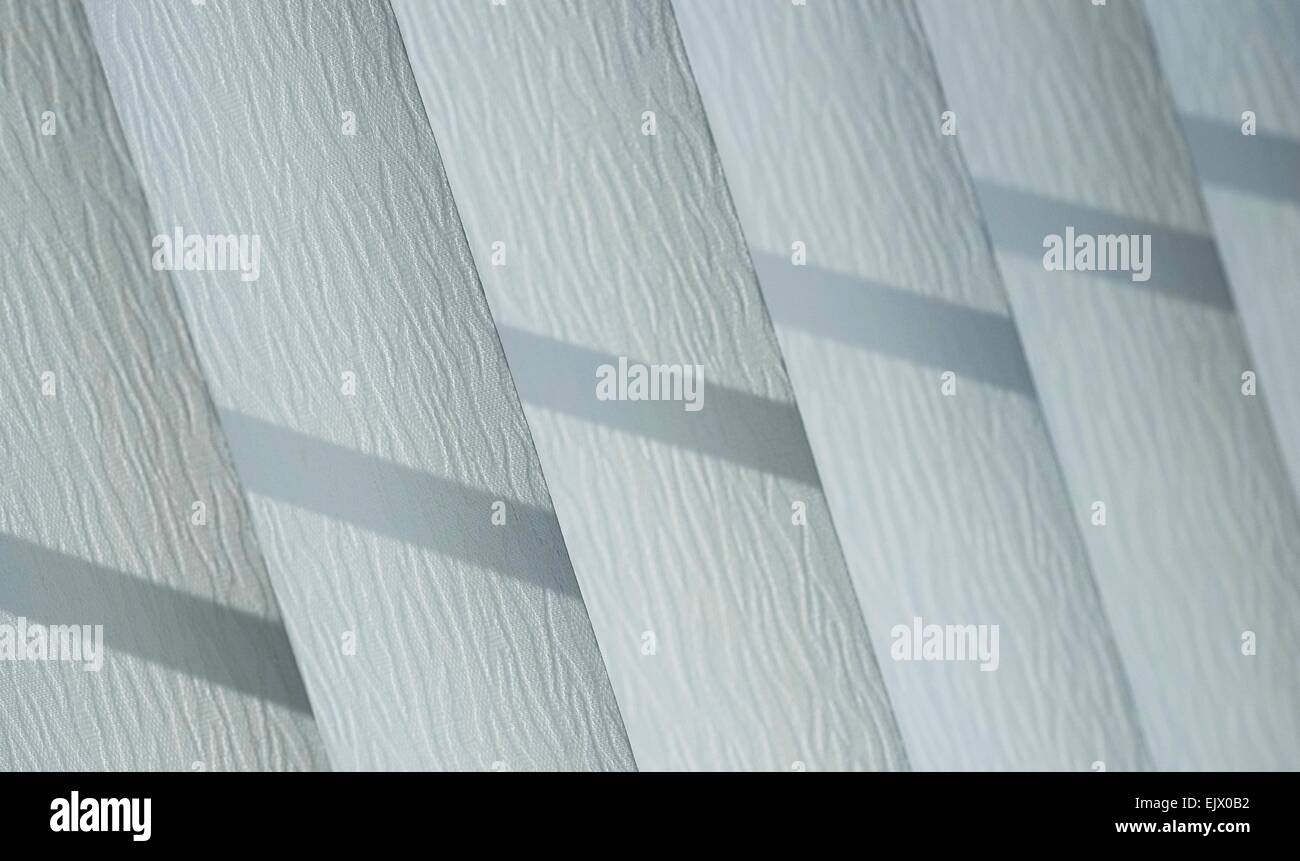 Vertical blinds with shadows from the sunlight Stock Photo - Alamy