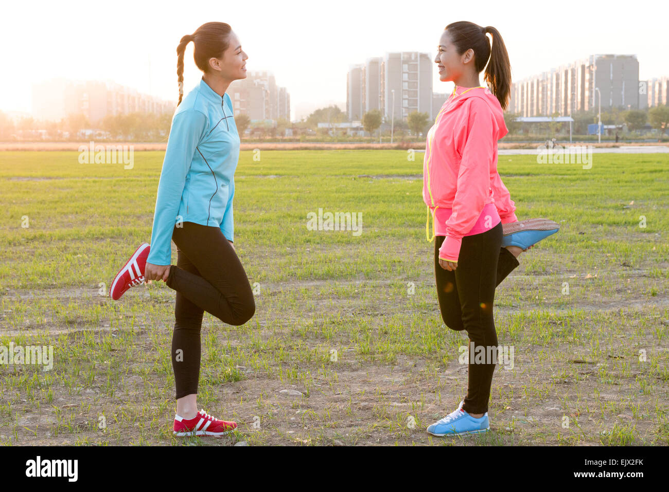 Girlfriends stretching before exercise Stock Photo - Alamy