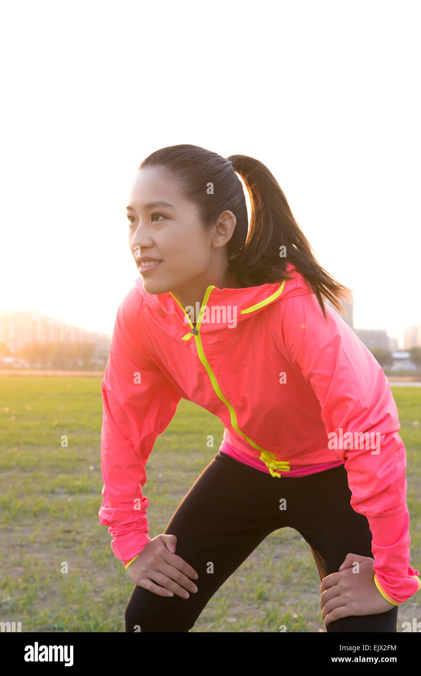 Young woman resting during exercise Stock Photo - Alamy