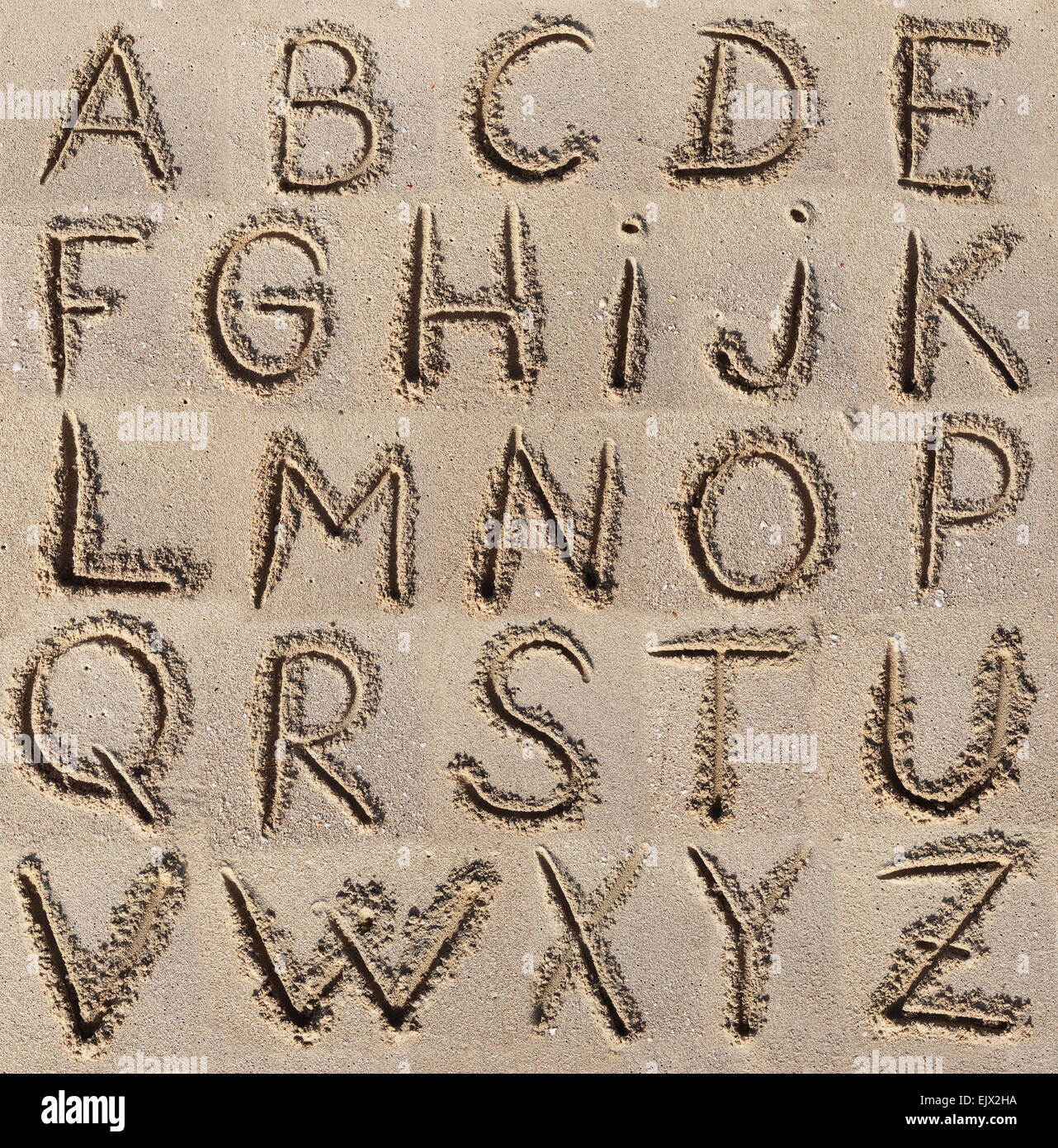Alphabet (ABC) written on sand Stock Photo - Alamy