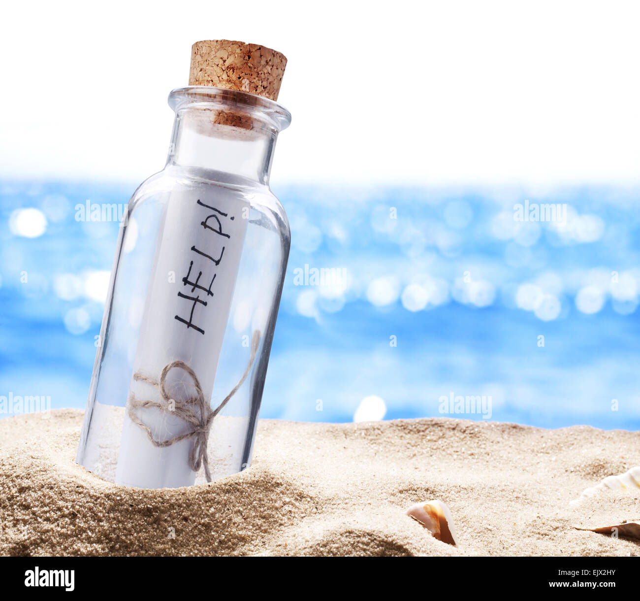 Bottle with a message for help. Sea beach Stock Photo - Alamy