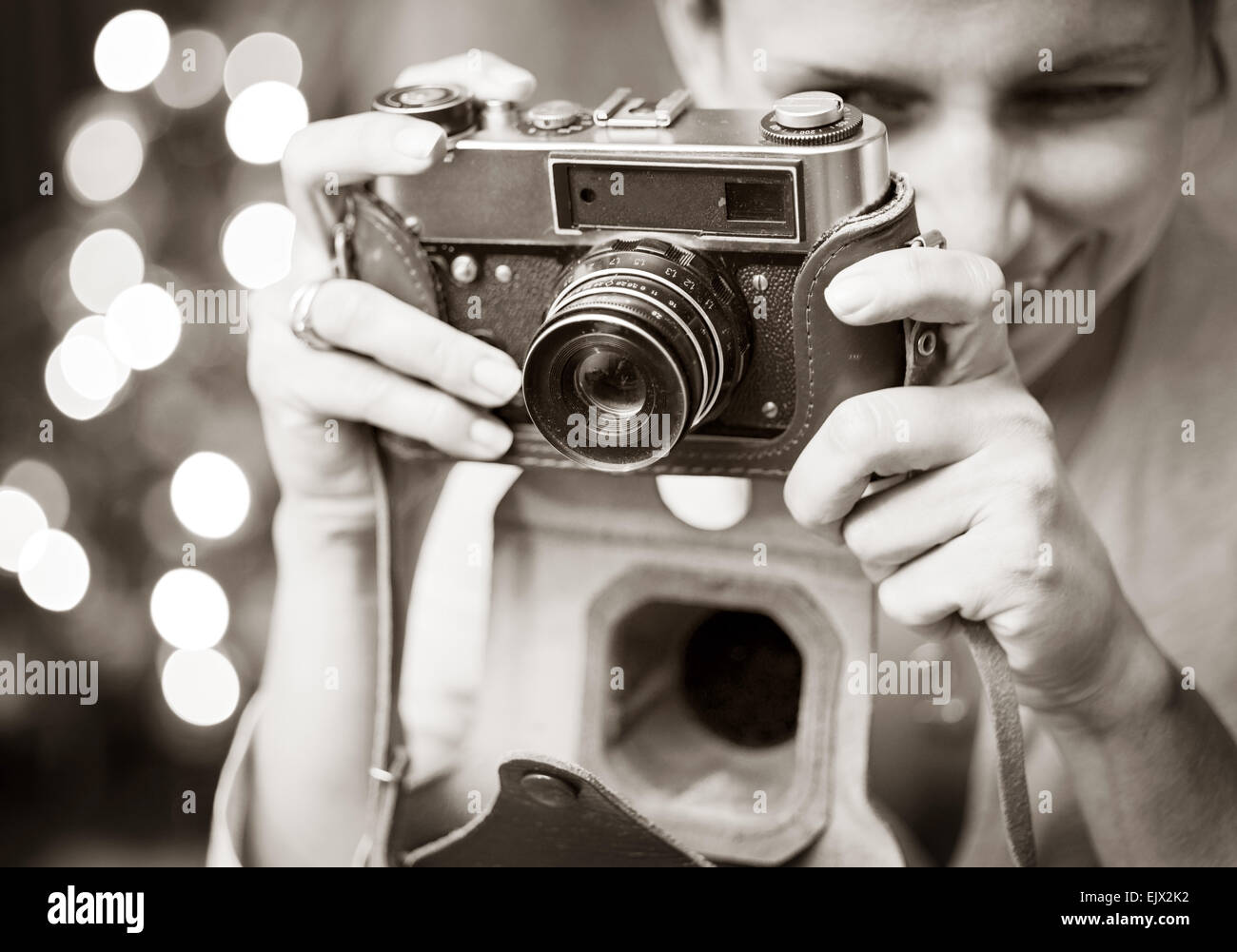 Smiling woman photographed retro camera. Black - white image processing ...