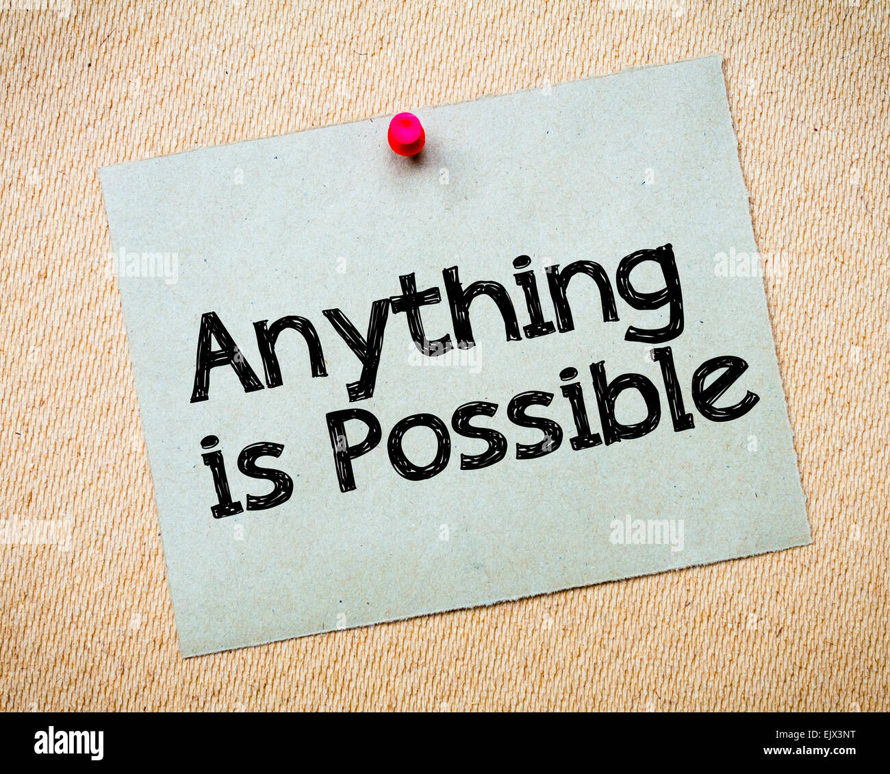 Anything is possible Message. Recycled paper note pinned on cork board ...