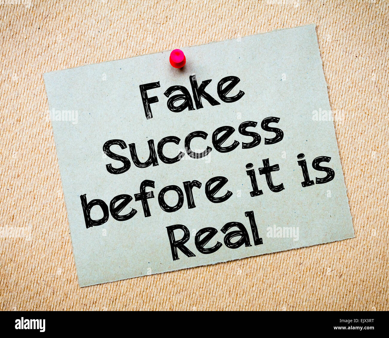 Fake success before it is real Message. Recycled paper note pinned on ...