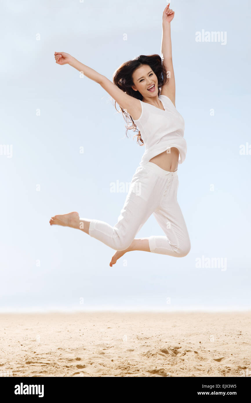 The young woman in the sea jump Stock Photo - Alamy