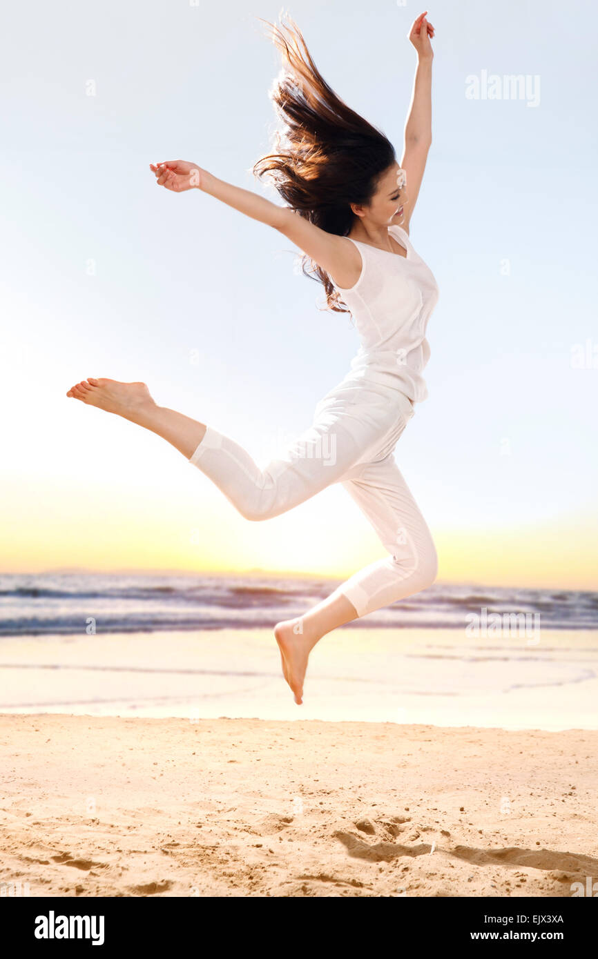 A beautiful young woman in the sea jump Stock Photo - Alamy