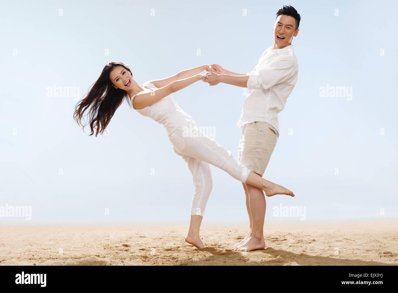 Romantic young lovers play on the beach Stock Photo - Alamy