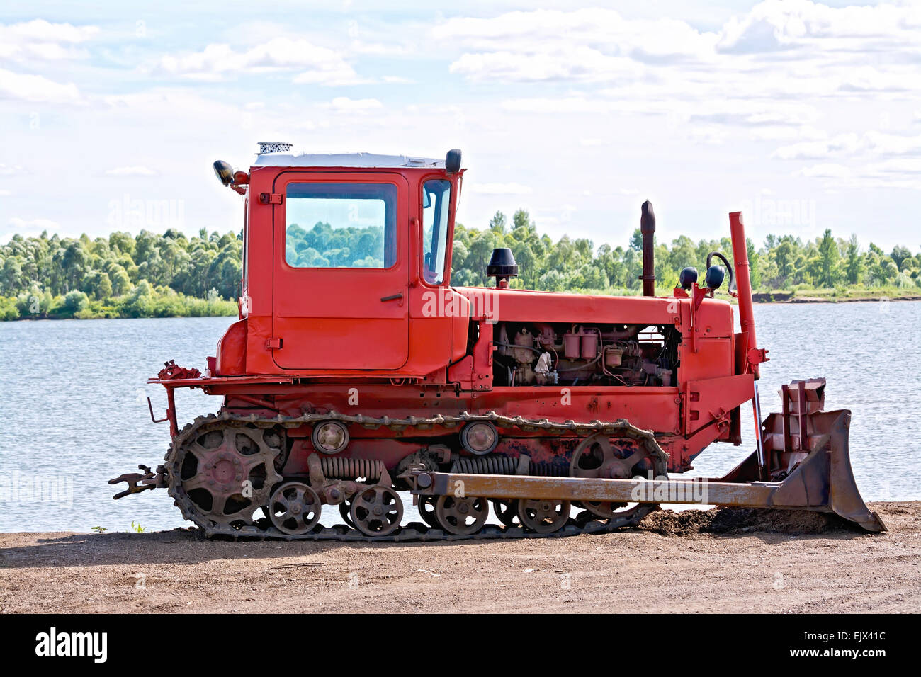 Bulldozer red by the river Stock Photo - Alamy