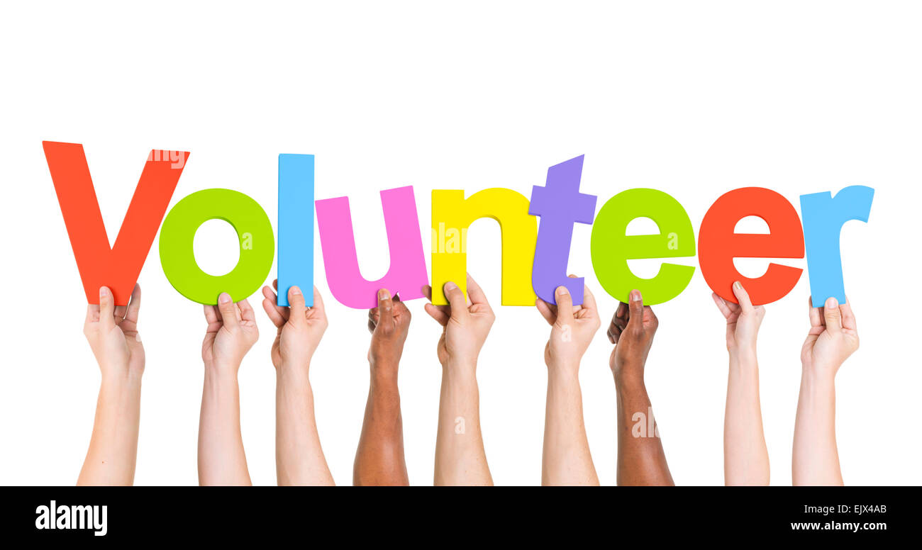 Diverse Hands Holding The Word Volunteer Stock Photo - Alamy
