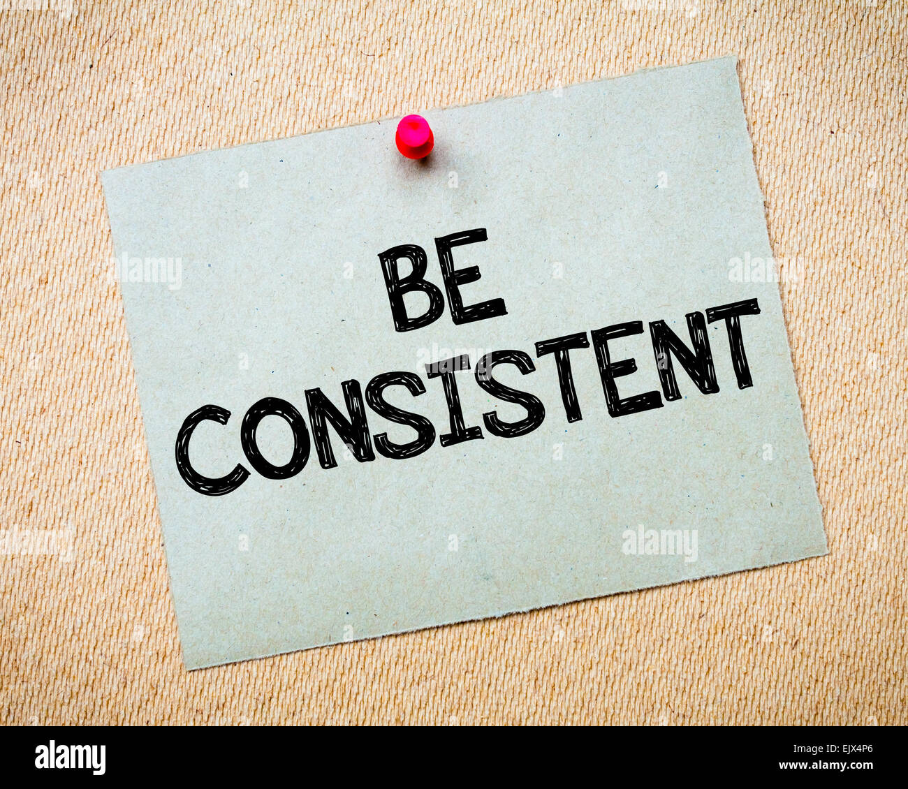 Be Consistent Message. Recycled paper note pinned on cork board ...