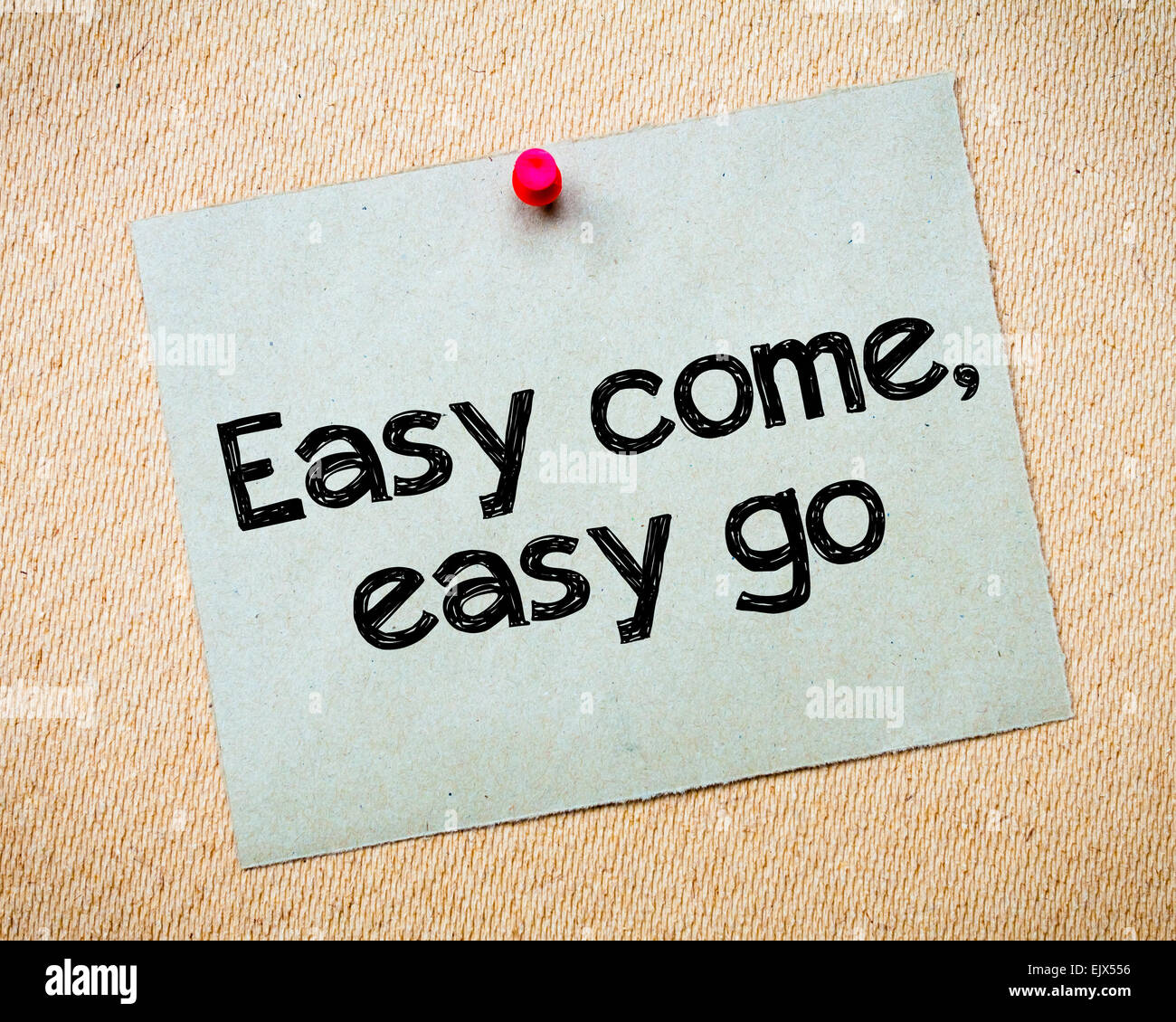 Easy come, easy go Message. Recycled paper note pinned on cork board ...