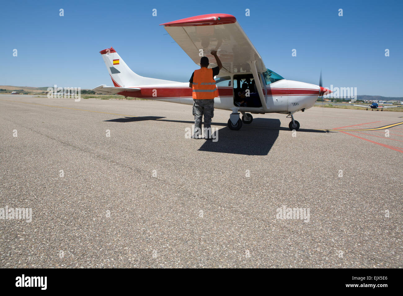The instructor check the plane just before take off Stock Photo - Alamy