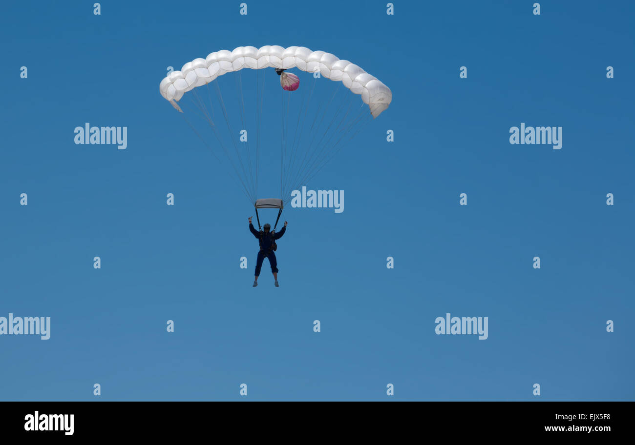 A skydiver performing skydiving with blue sky in the background Stock ...