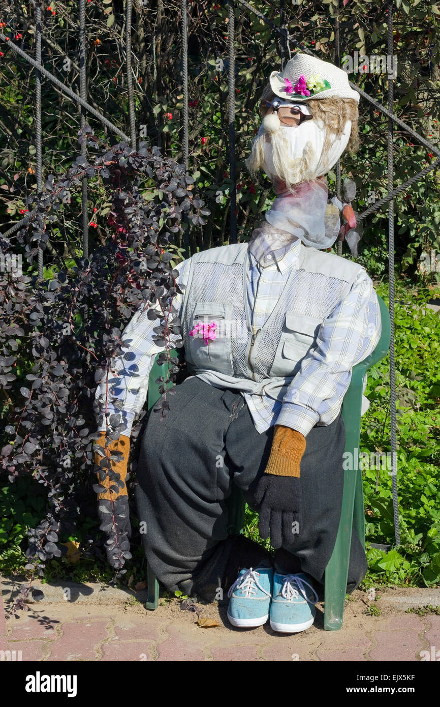 The handmade naive effigy - dummy is dressed in clothes of the peasant ...