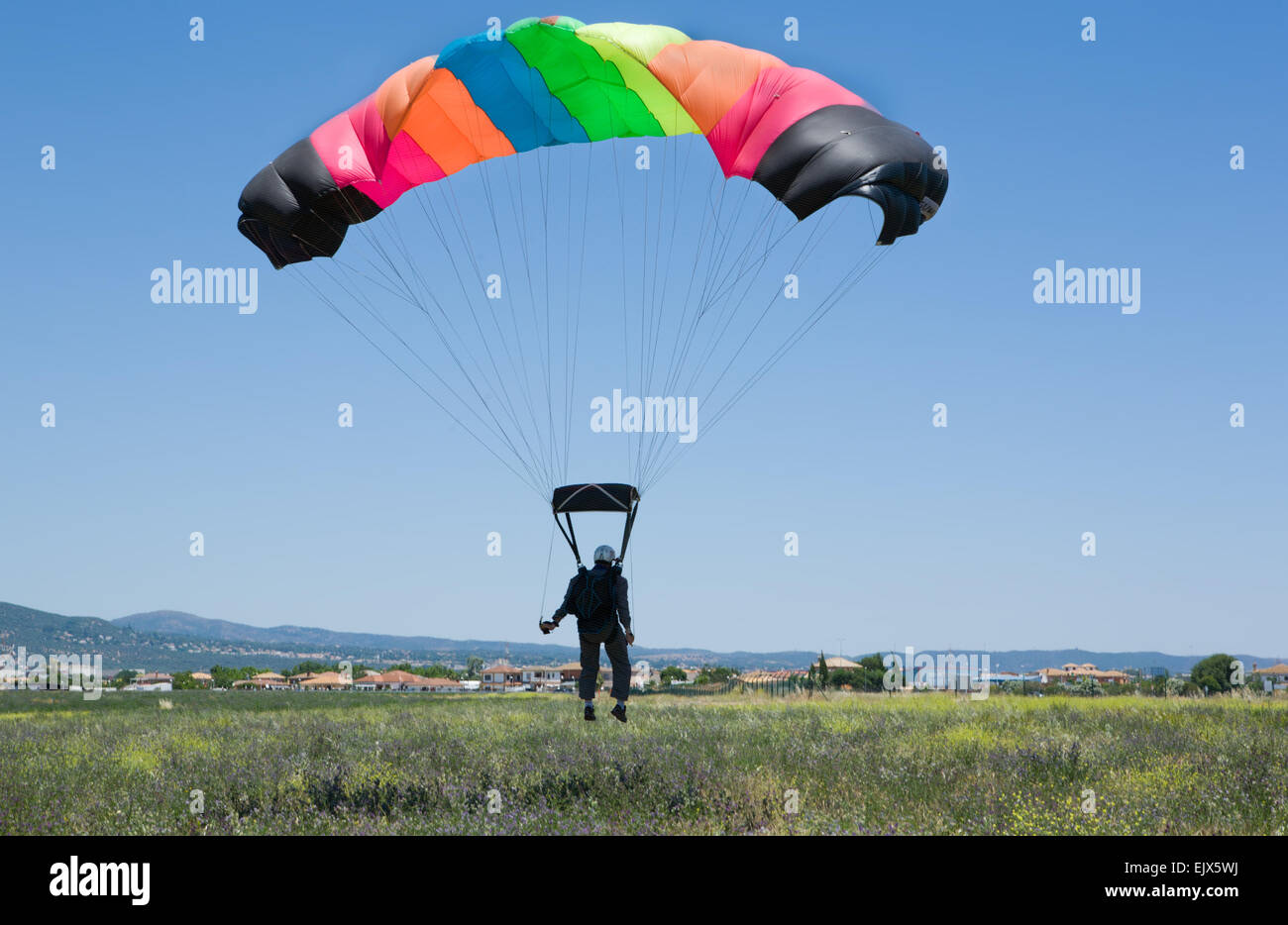 A skydiver performing skydiving with blue sky in the background Stock ...