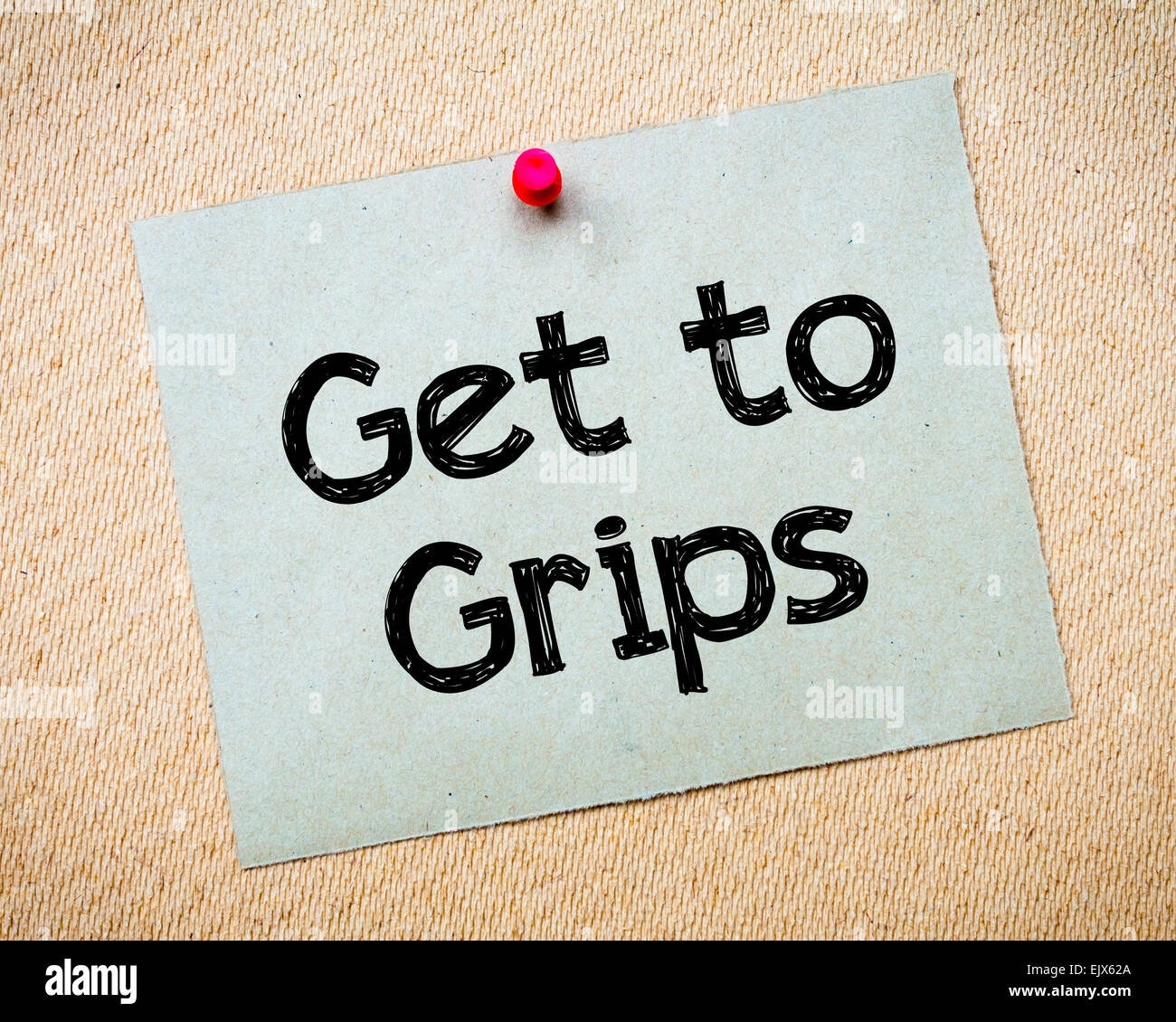 Get the grips Message. Recycled paper note pinned on cork board ...