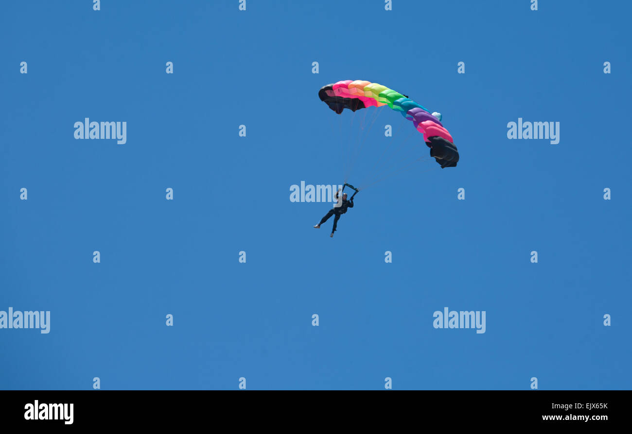 A skydiver performing skydiving with blue sky in the background Stock ...