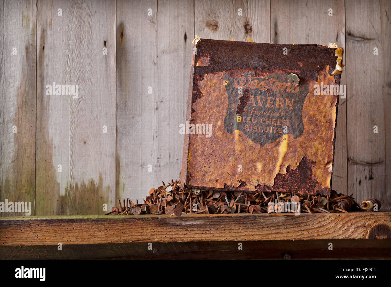 Nails rusted through a biscuit tin Stock Photo - Alamy