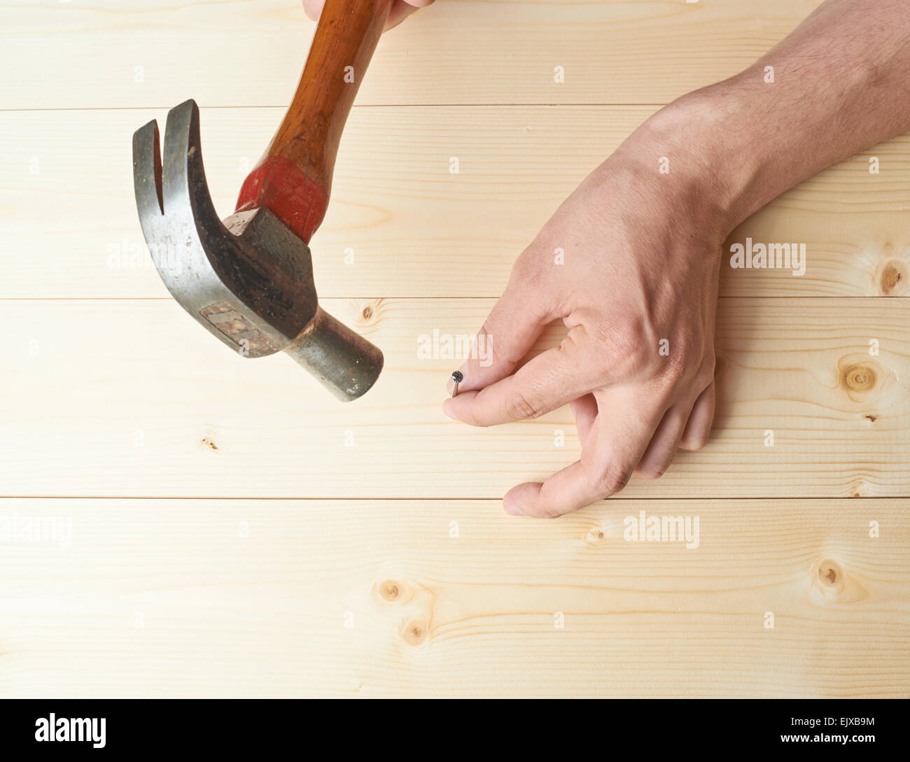 Hammering the nail composition Stock Photo - Alamy