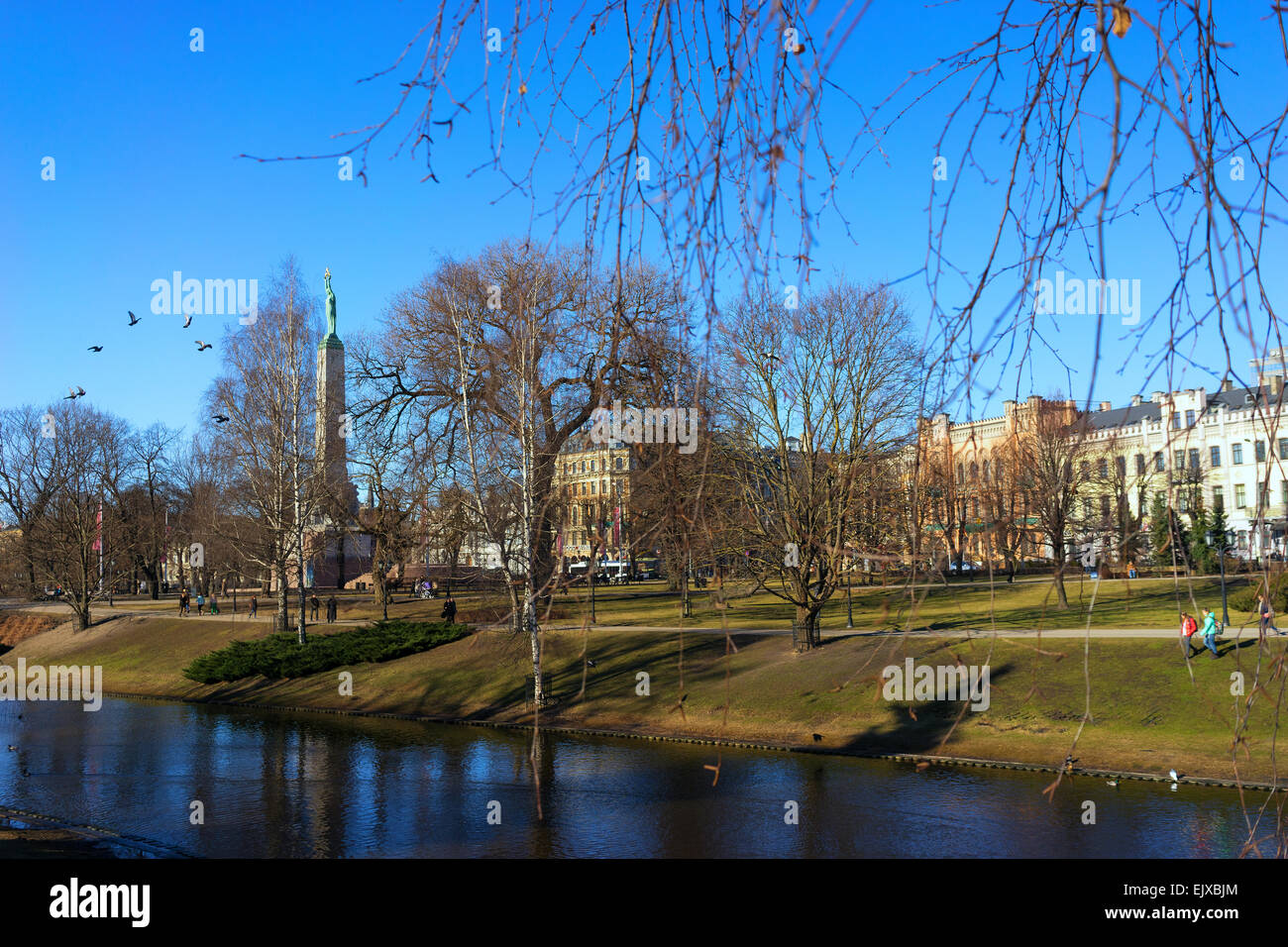 City canal with trees and blue in the blue sky at the Monument of ...