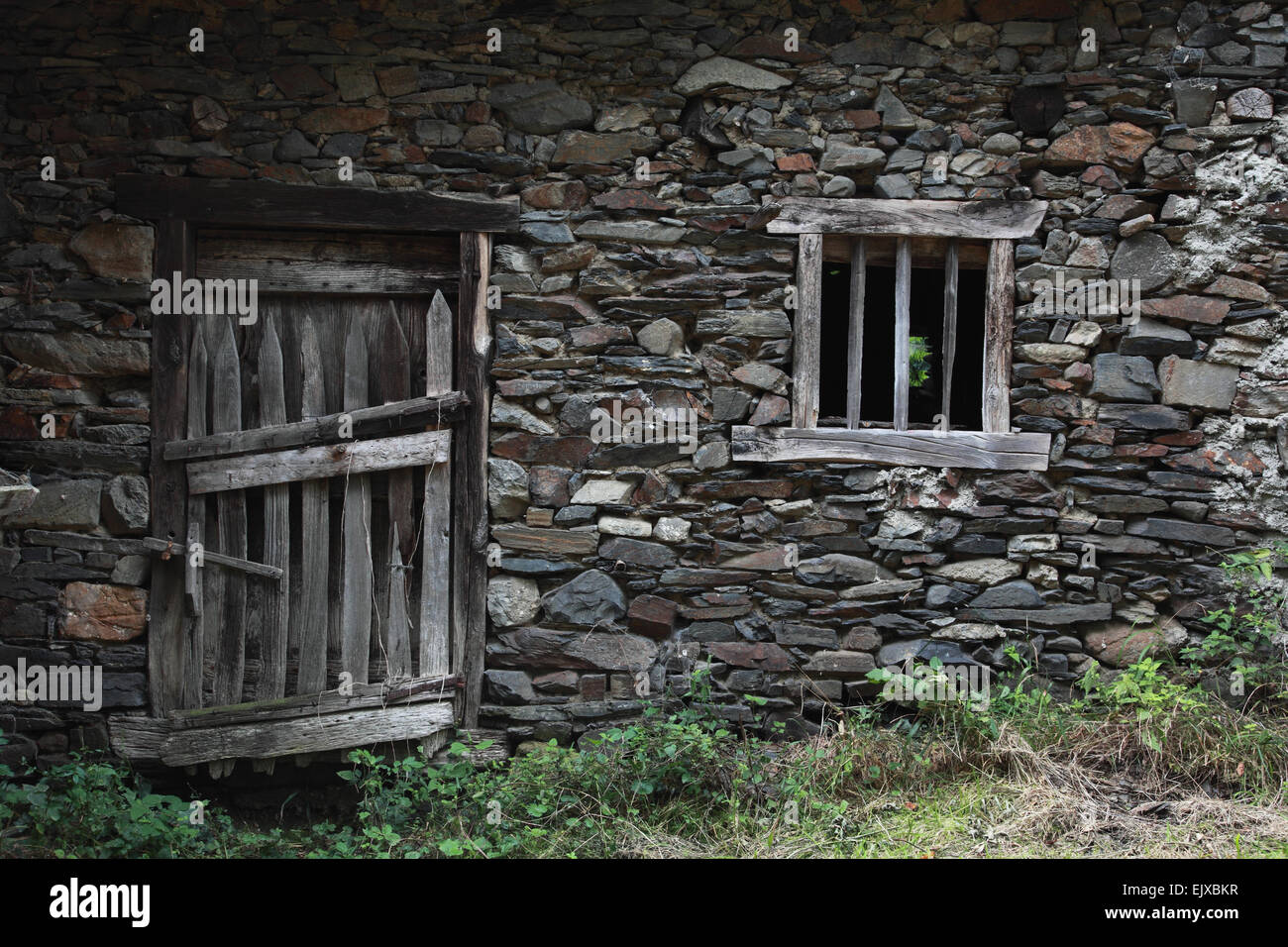 Traditional stone built barn with local style of wooden door and window ...