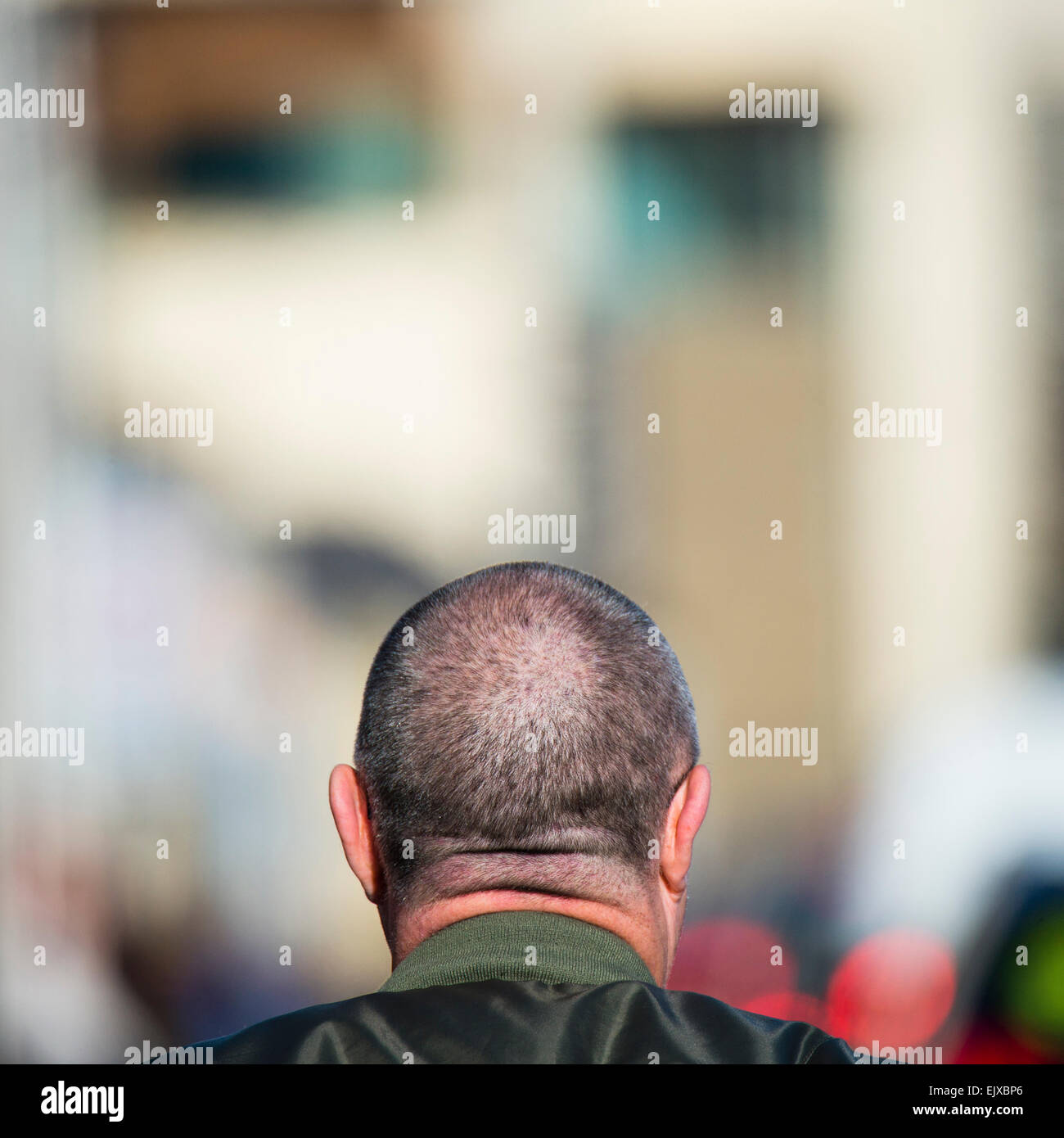 Rear view of a the head and neck of a man with a close cropped shaved ...
