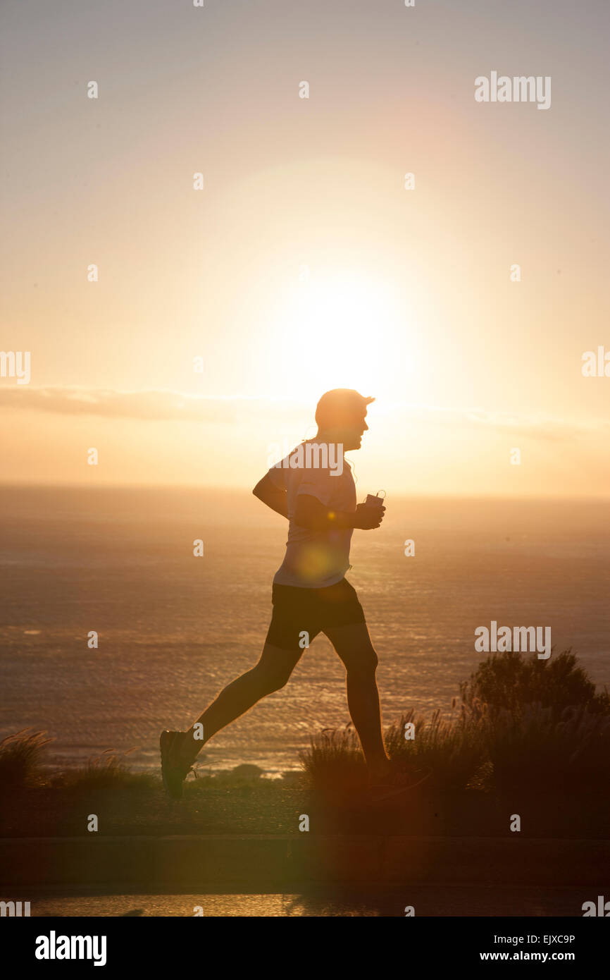 Man running into sunset hi-res stock photography and images - Alamy
