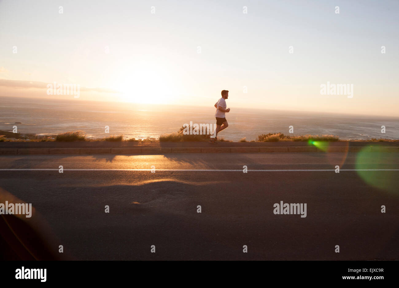 Man Running at Sunset Stock Photo - Alamy