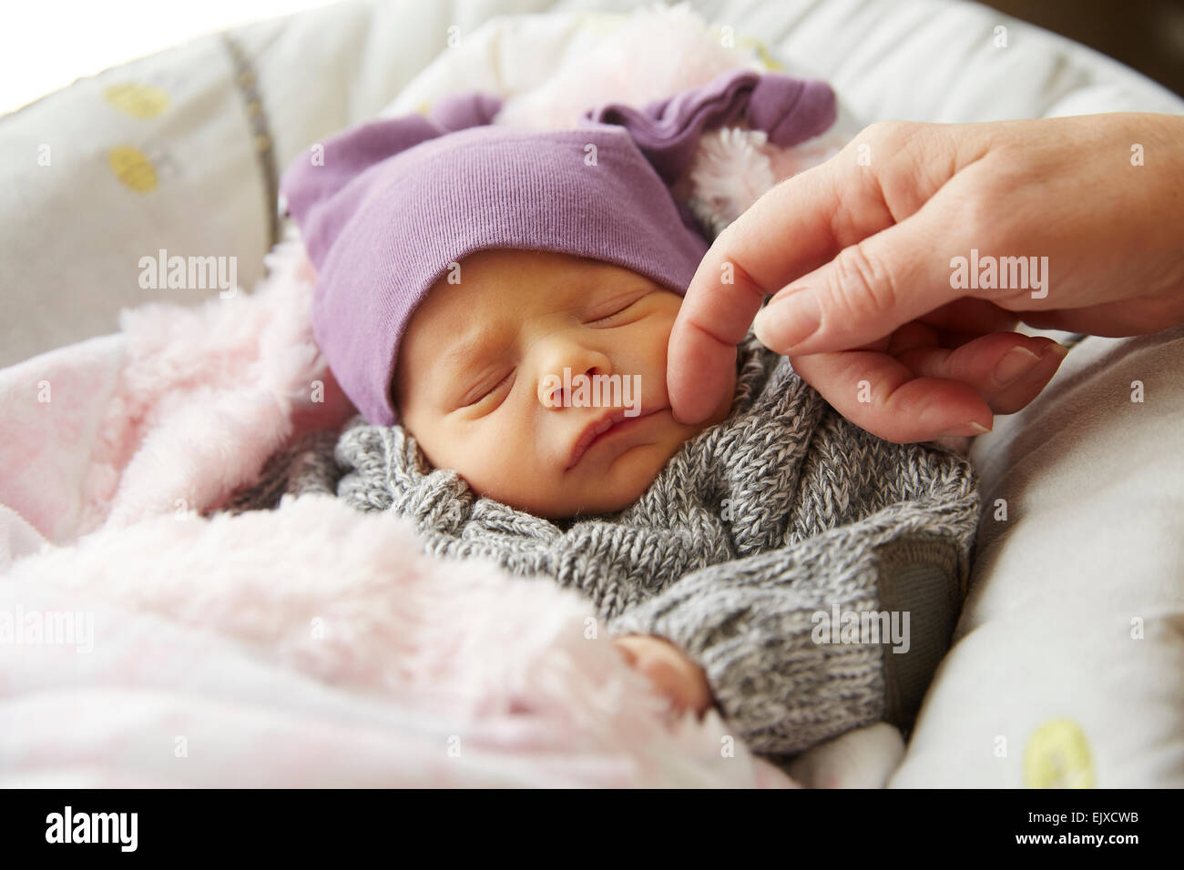 Hand caressing baby girl face hi-res stock photography and images - Alamy