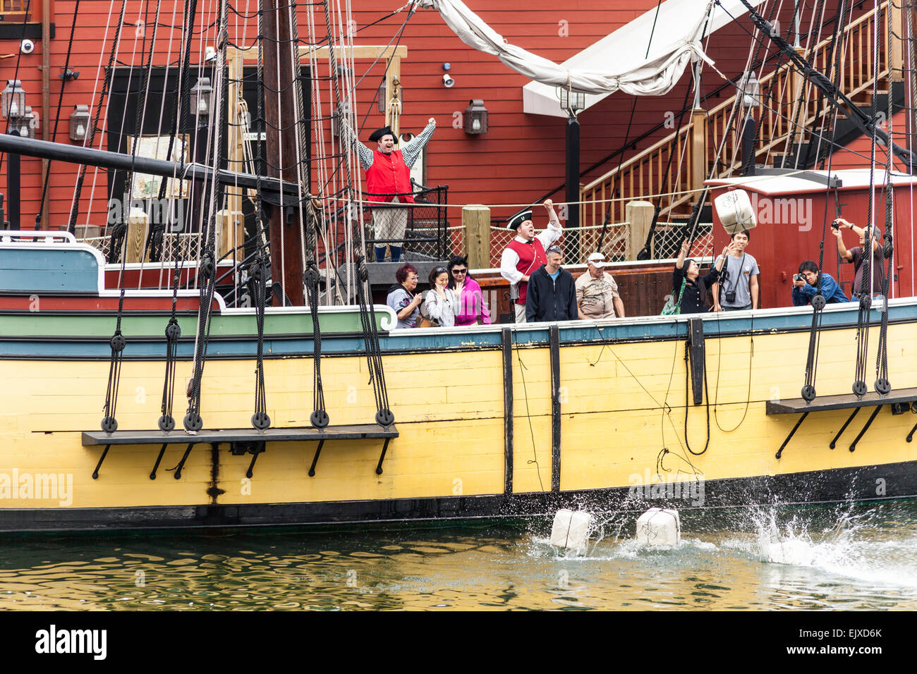 Tourists throwing tea chests from Beaver, replica of one of Boston Tea ...