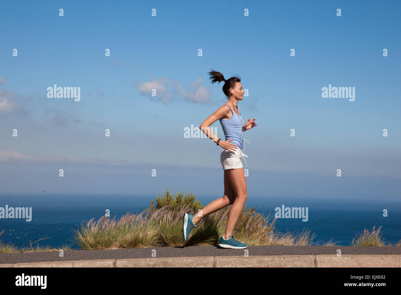 Woman running road hi-res stock photography and images - Alamy