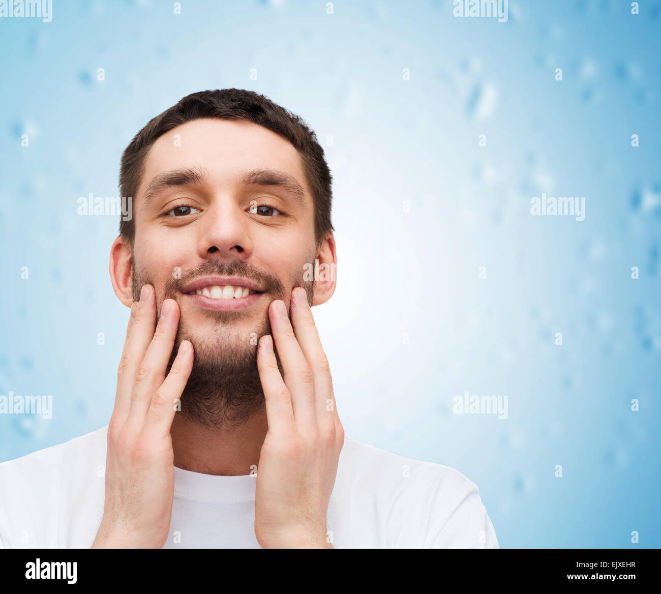 beautiful smiling man touching his face Stock Photo - Alamy