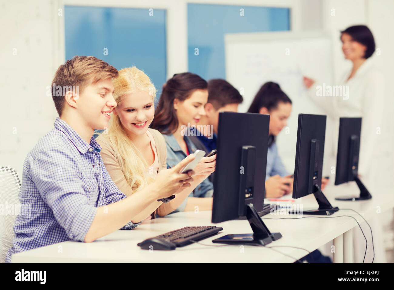 students with computer monitor and smartphones Stock Photo - Alamy
