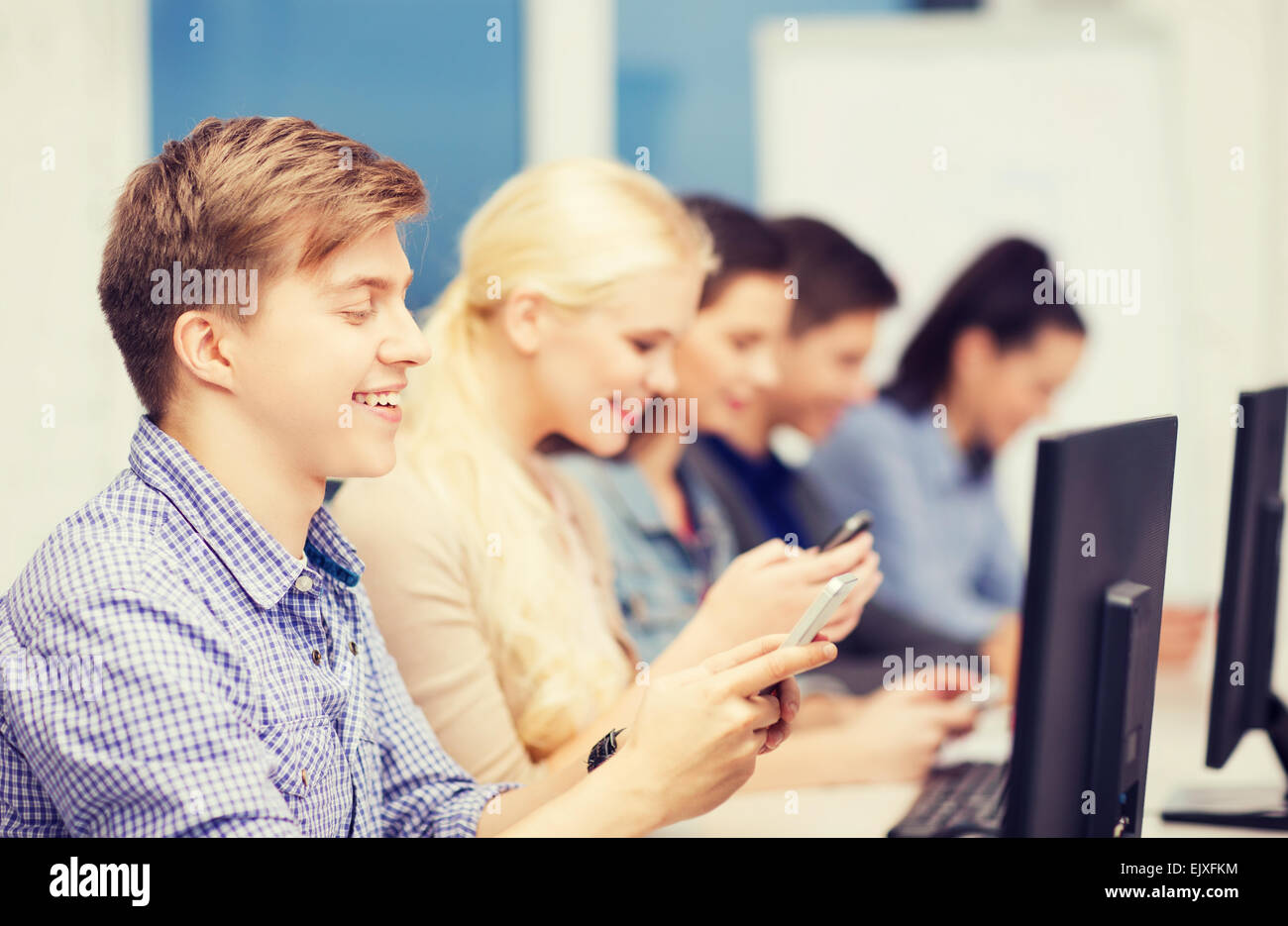 students with computer monitor and smartphones Stock Photo - Alamy