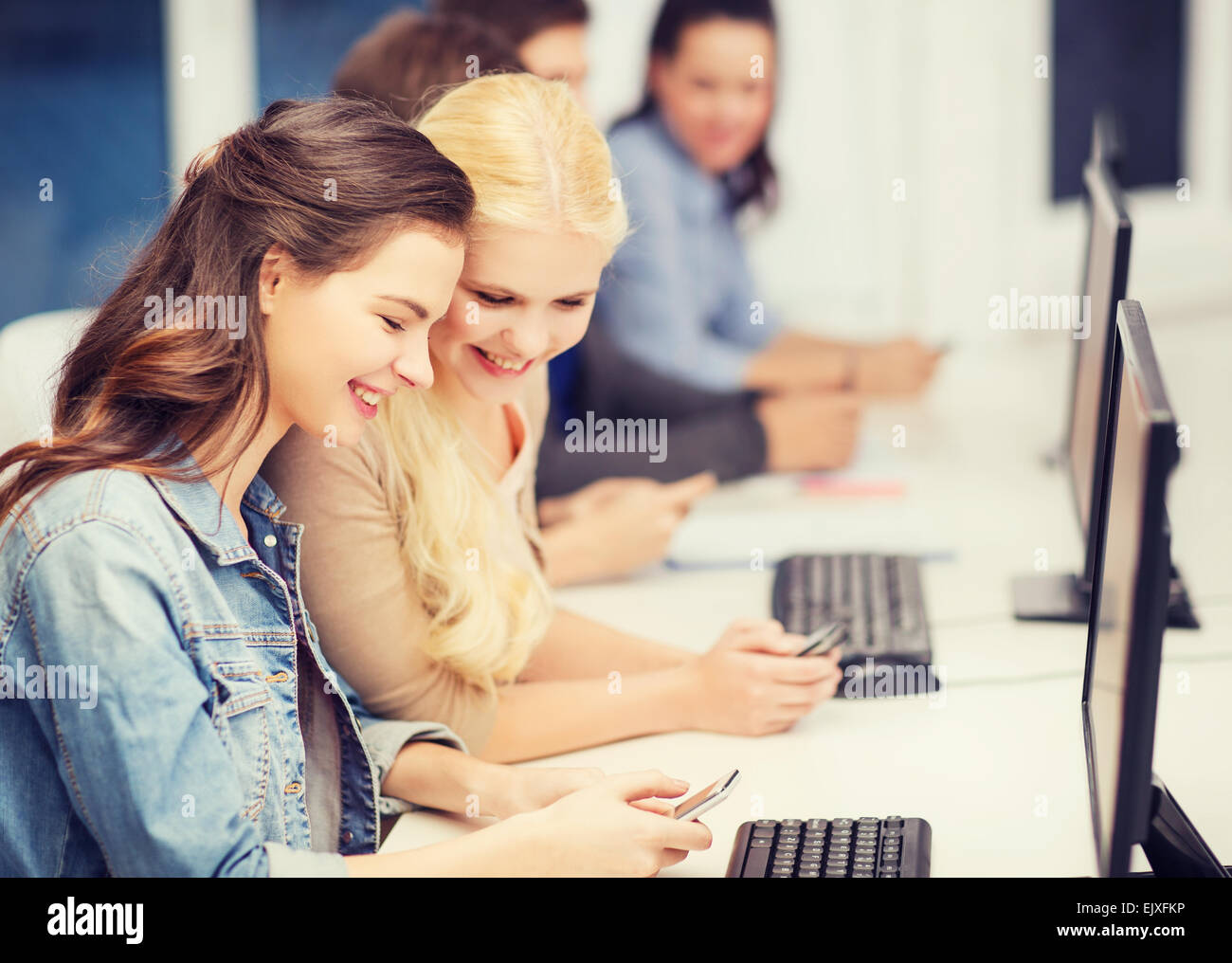 students with computer monitor and smartphones Stock Photo - Alamy