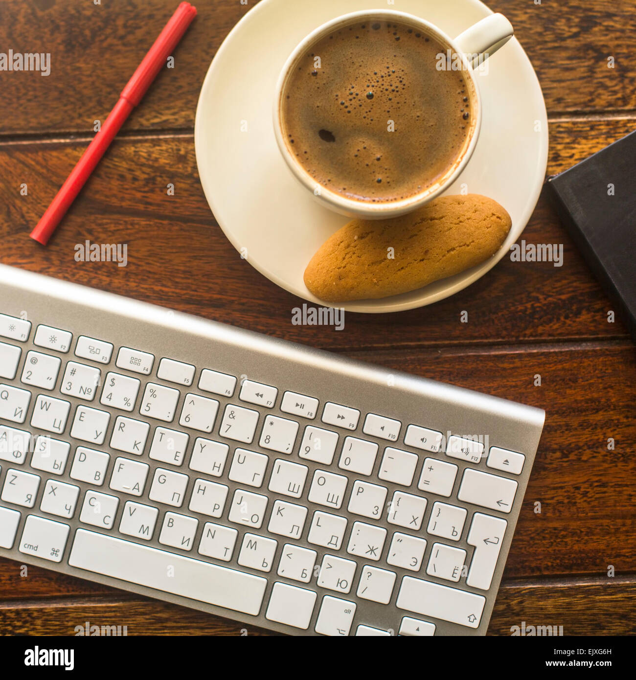 Keyboard and a Cup of coffee on a dark wooden table top view Stock ...