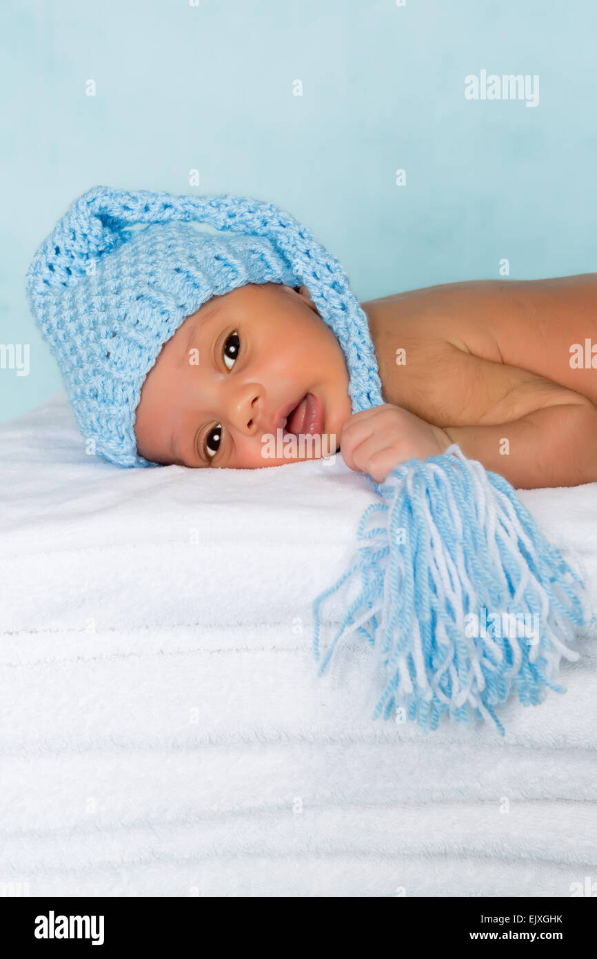 Newborn african baby with knitted blue bonnet Stock Photo - Alamy