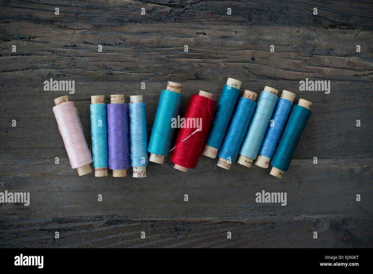 Row of different cotton reels on wood Stock Photo - Alamy