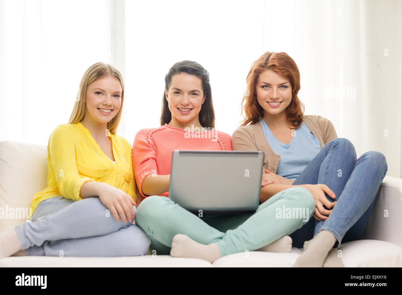 three smiling teenage girls with laptop at home Stock Photo - Alamy