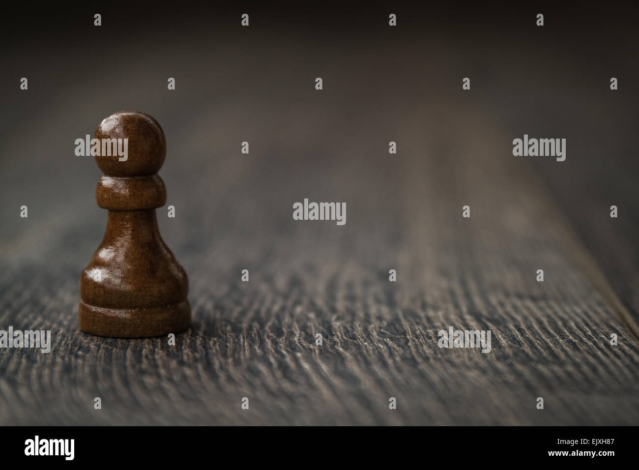 Black Pawn, chess piece on a brown wooden table and background Stock ...