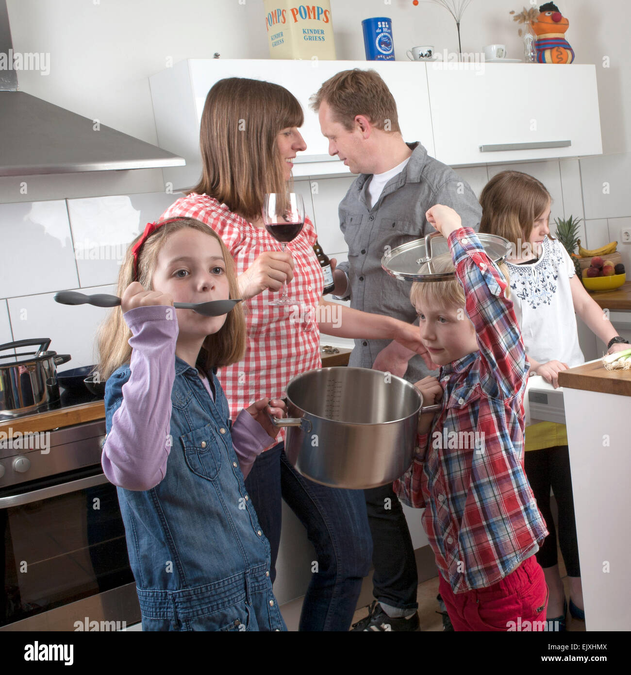 Family with three children cooking together Stock Photo - Alamy