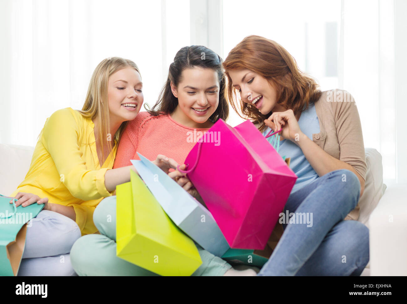 smiling teenage girls with many shopping bags Stock Photo - Alamy