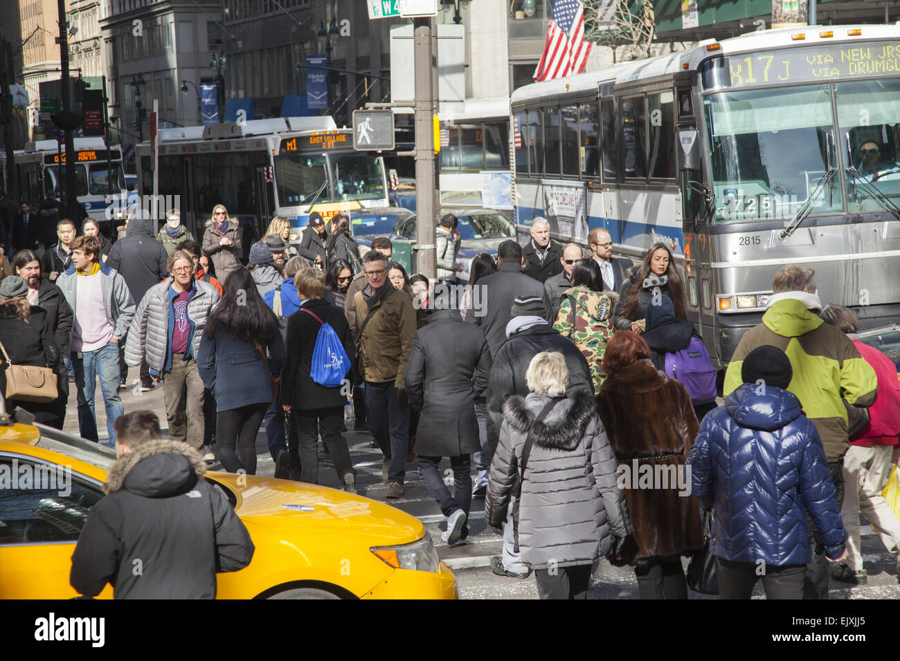 The ever crowded intersection of 42nd Street and Fifth Avenue in ...