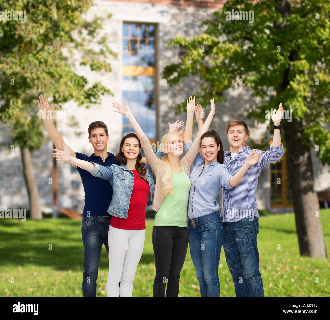 group of smiling students waving hands Stock Photo - Alamy