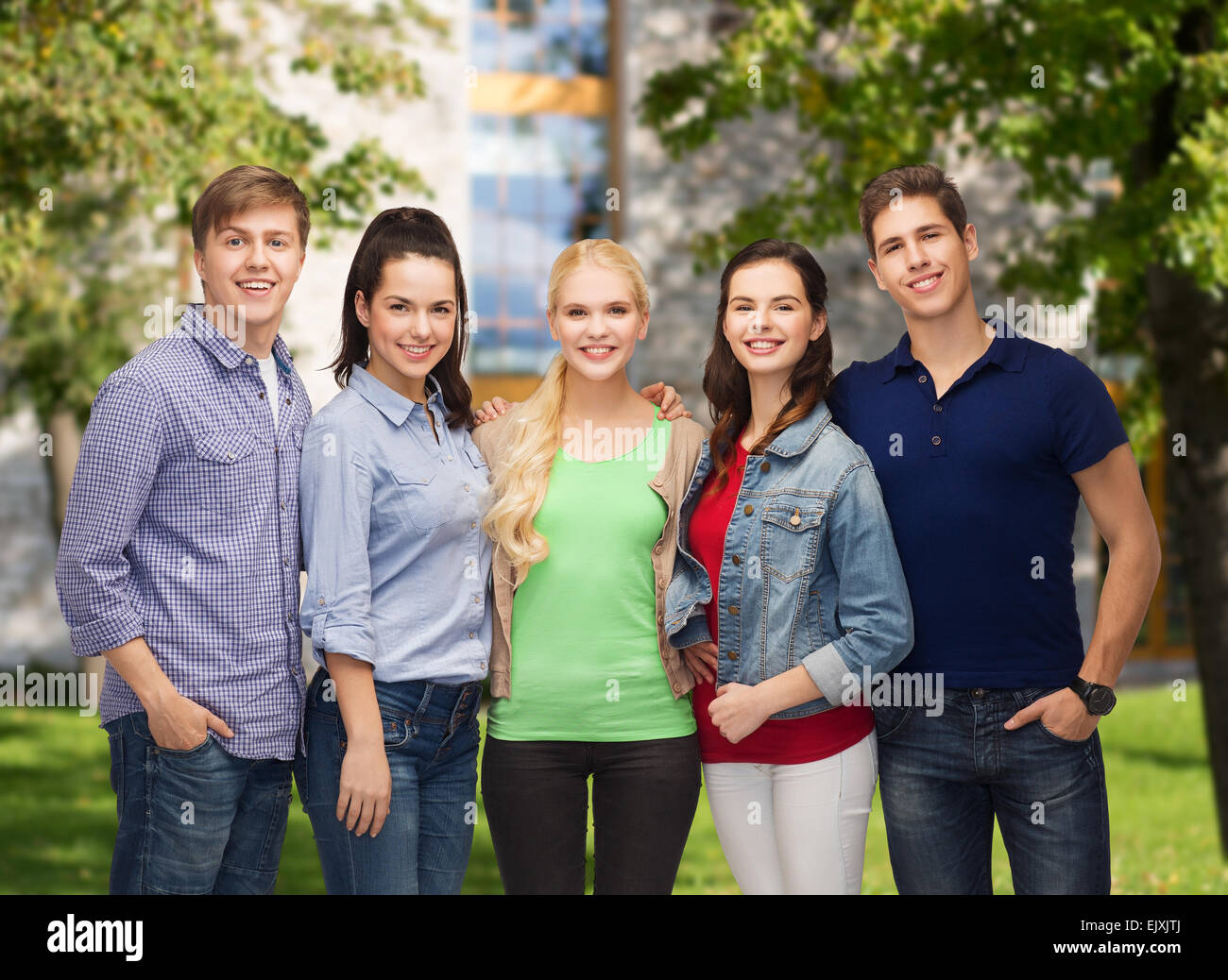 group of standing smiling students Stock Photo - Alamy