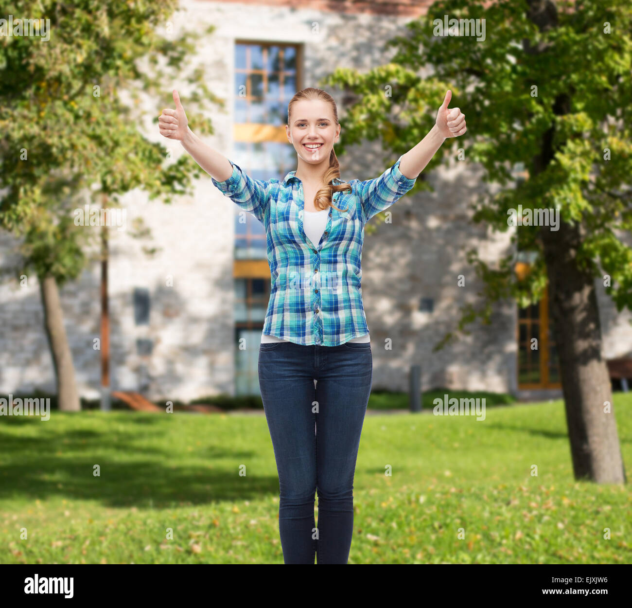 smiling girl in casual clothes showing thumbs up Stock Photo - Alamy