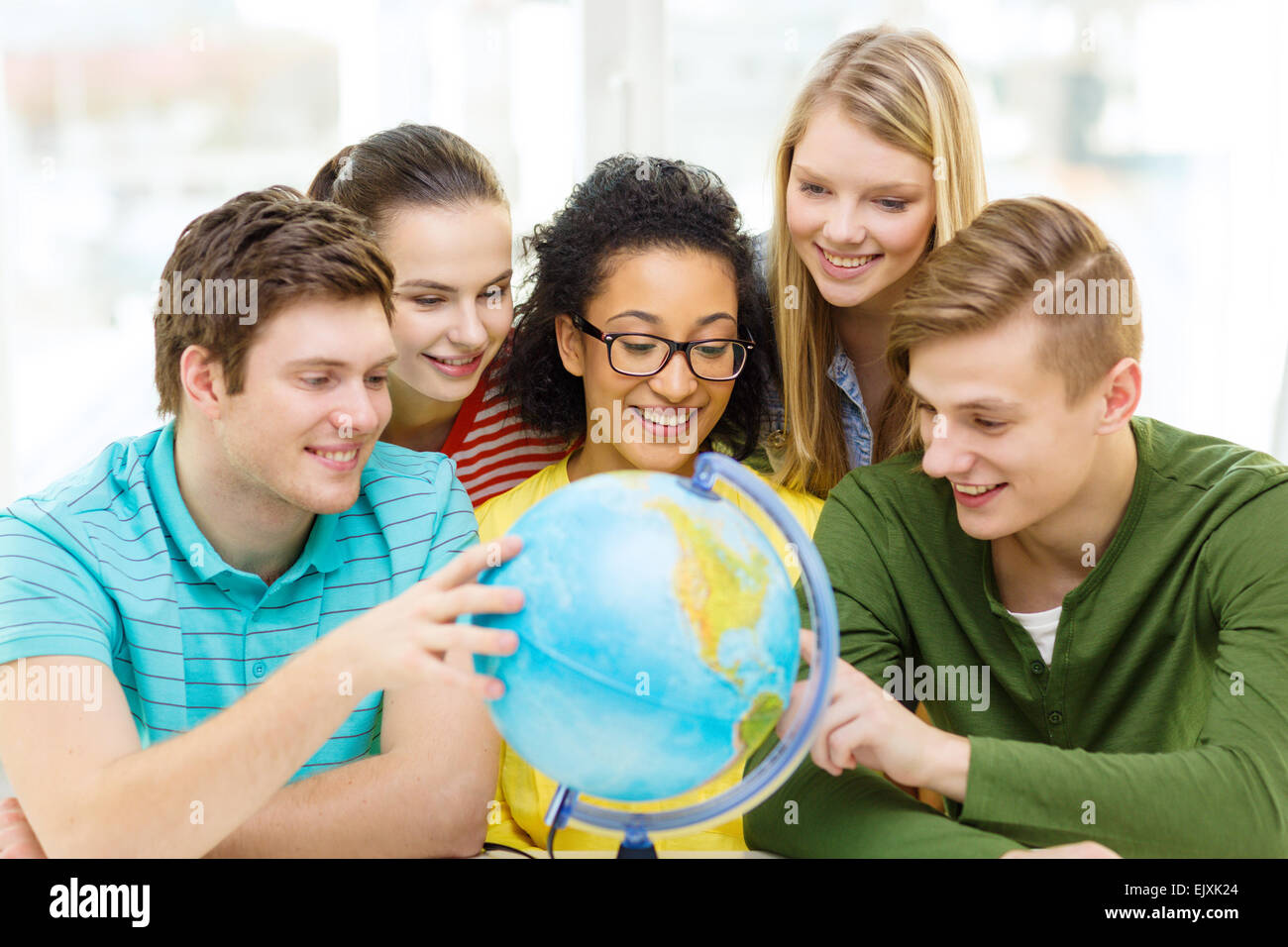 Happy students holding globe hi-res stock photography and images - Alamy